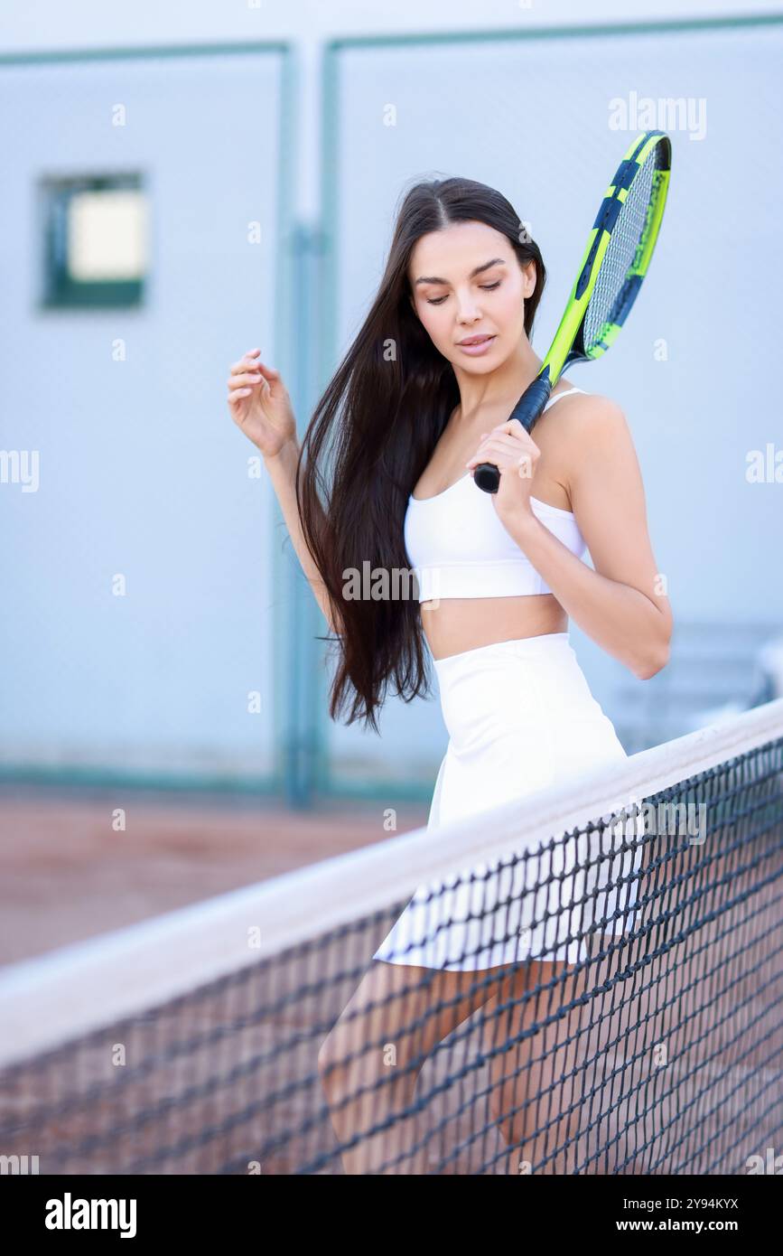 Beautiful woman with tennis racket on court Stock Photo - Alamy