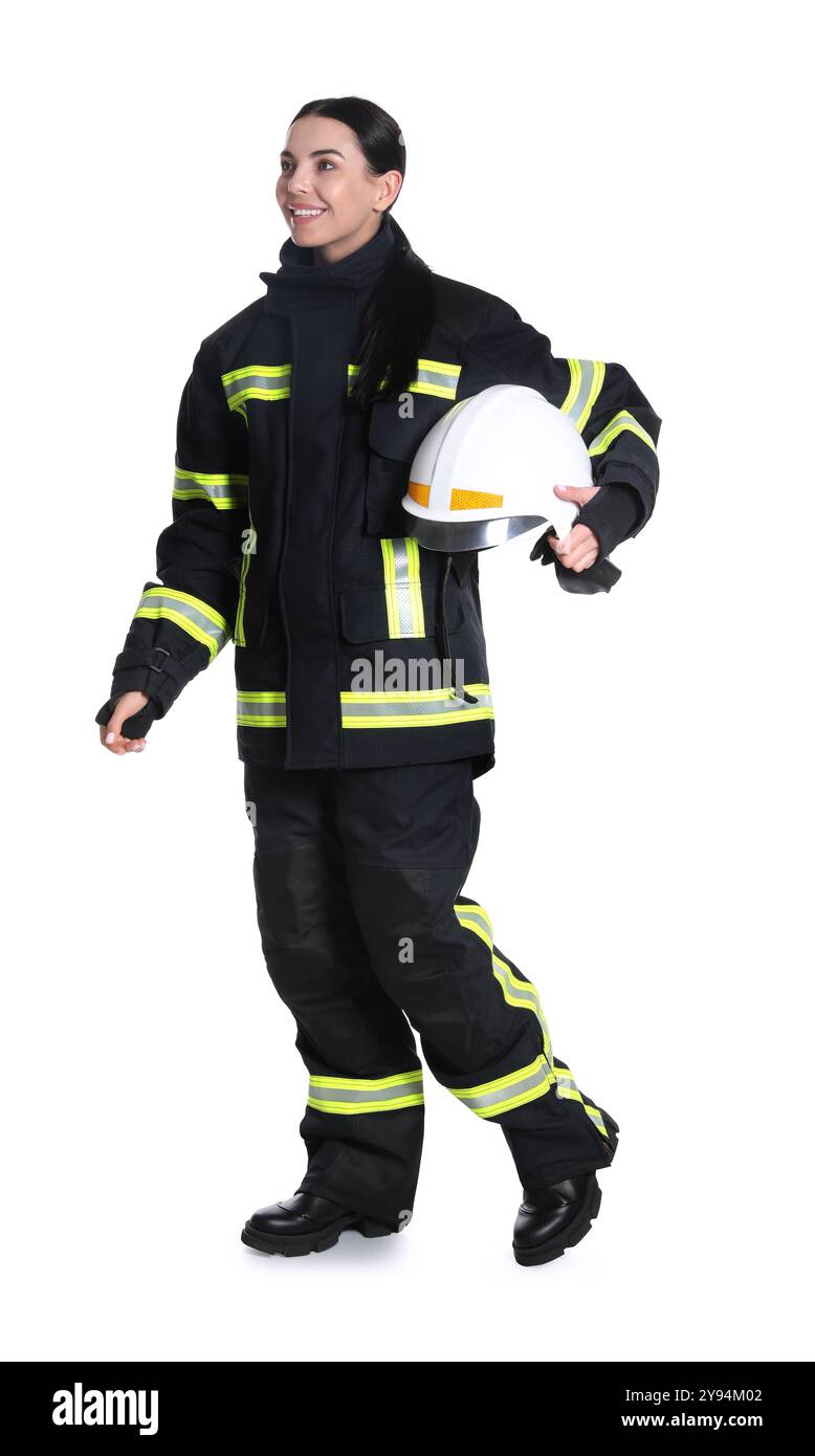 Full length portrait of firefighter in uniform with helmet on white ...