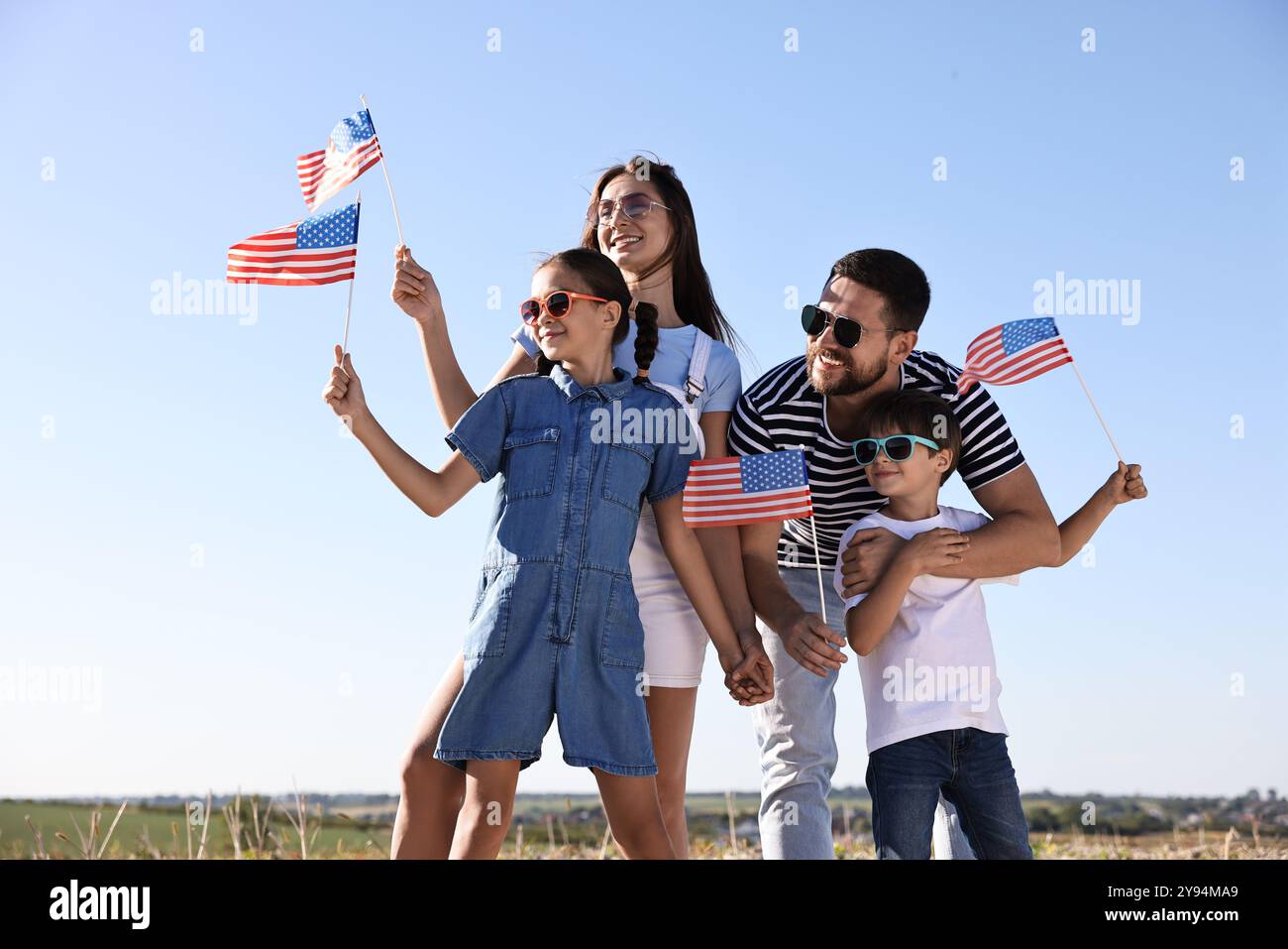 Happy family with flags of USA outdoors Stock Photo - Alamy