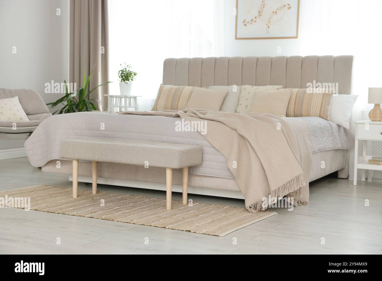 Big comfortable bed in room. Interior design Stock Photo - Alamy