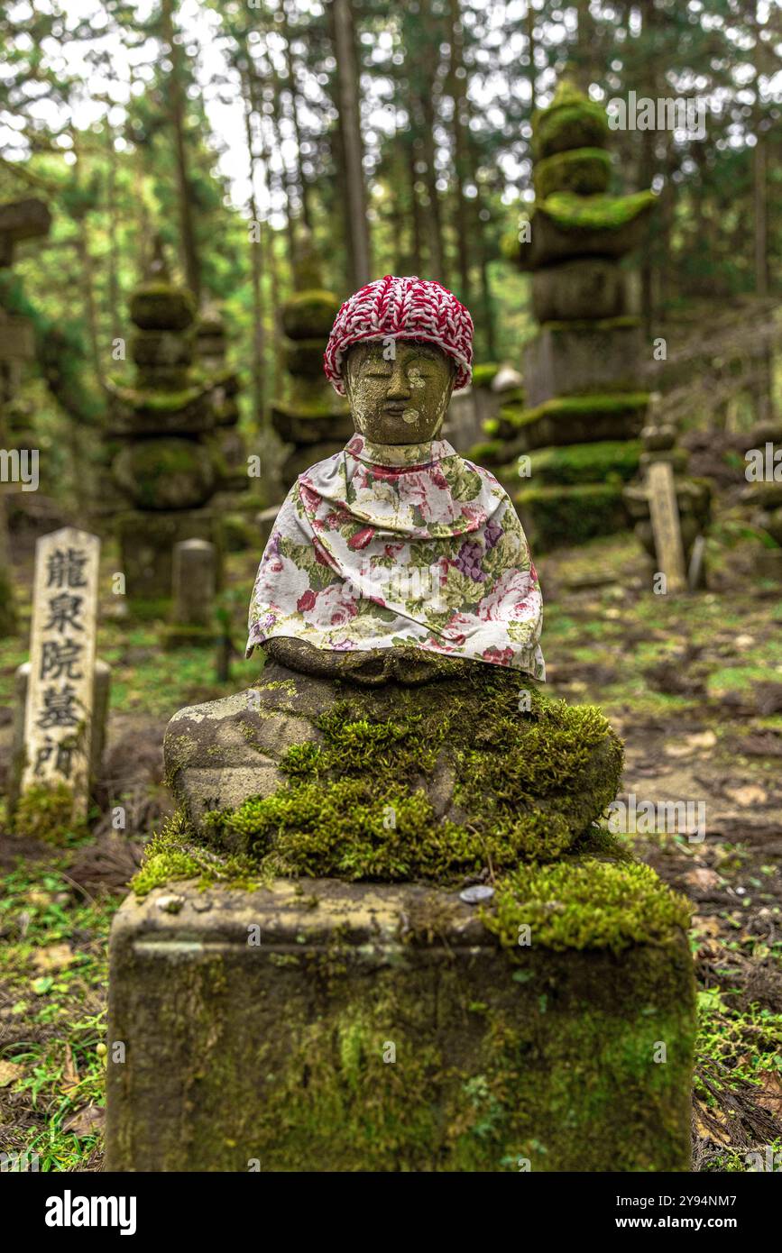 Ancient jizo statue wearing a knitted hat. Okunoin Gobyo, koya san ...