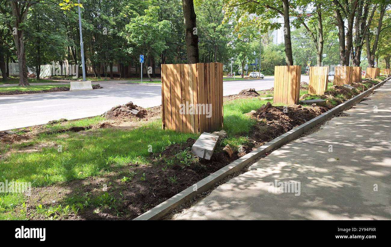 Urban tree protection with wooden panels on city sidewalk Stock Photo ...