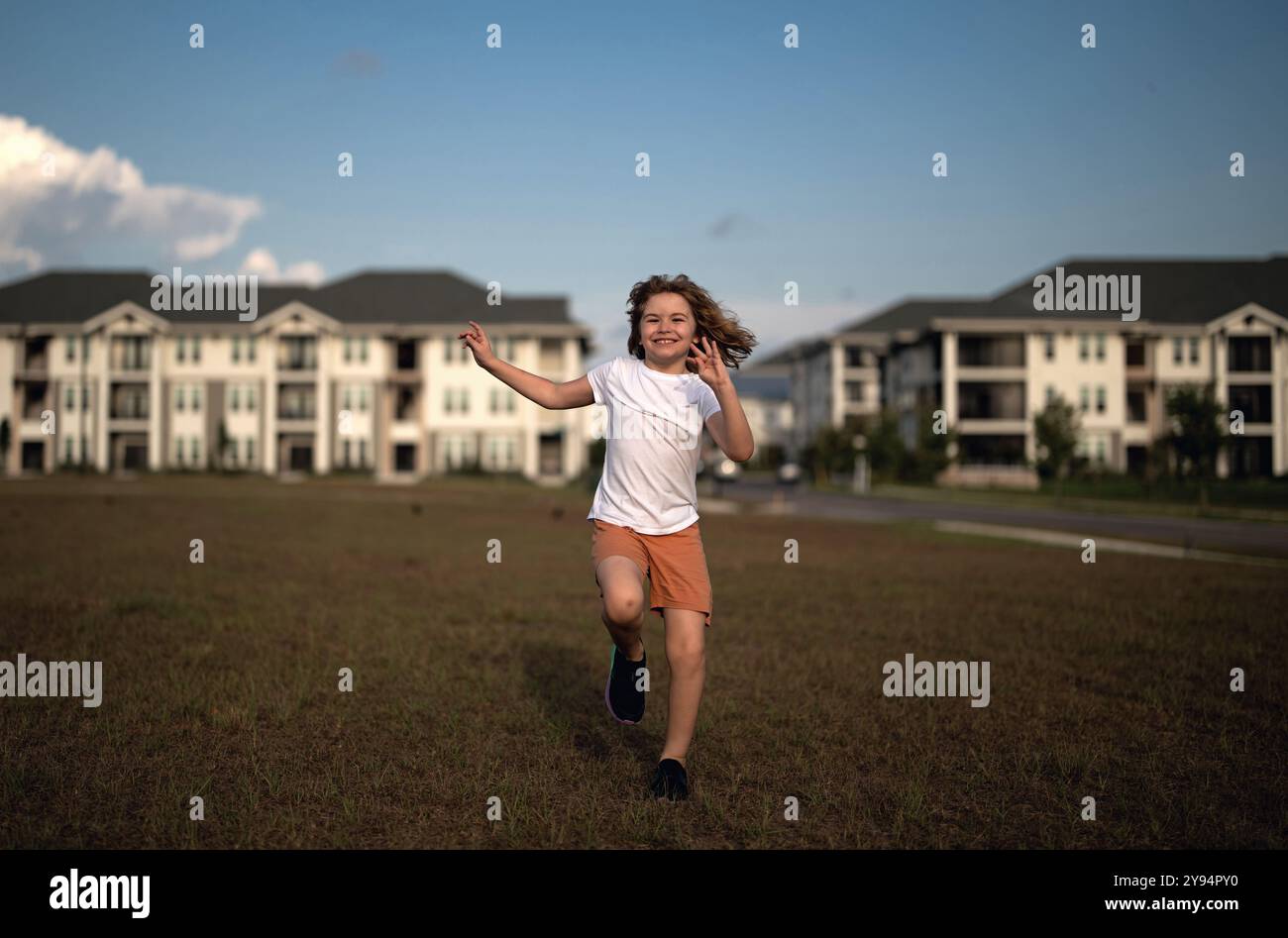 Child run. Excited kid boy running on grass. Kid boy playing and ...