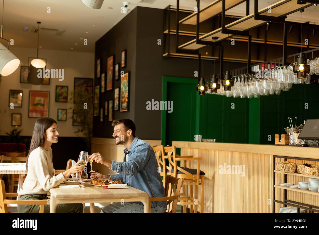 A couple engages in lively conversation while savoring delicious ...