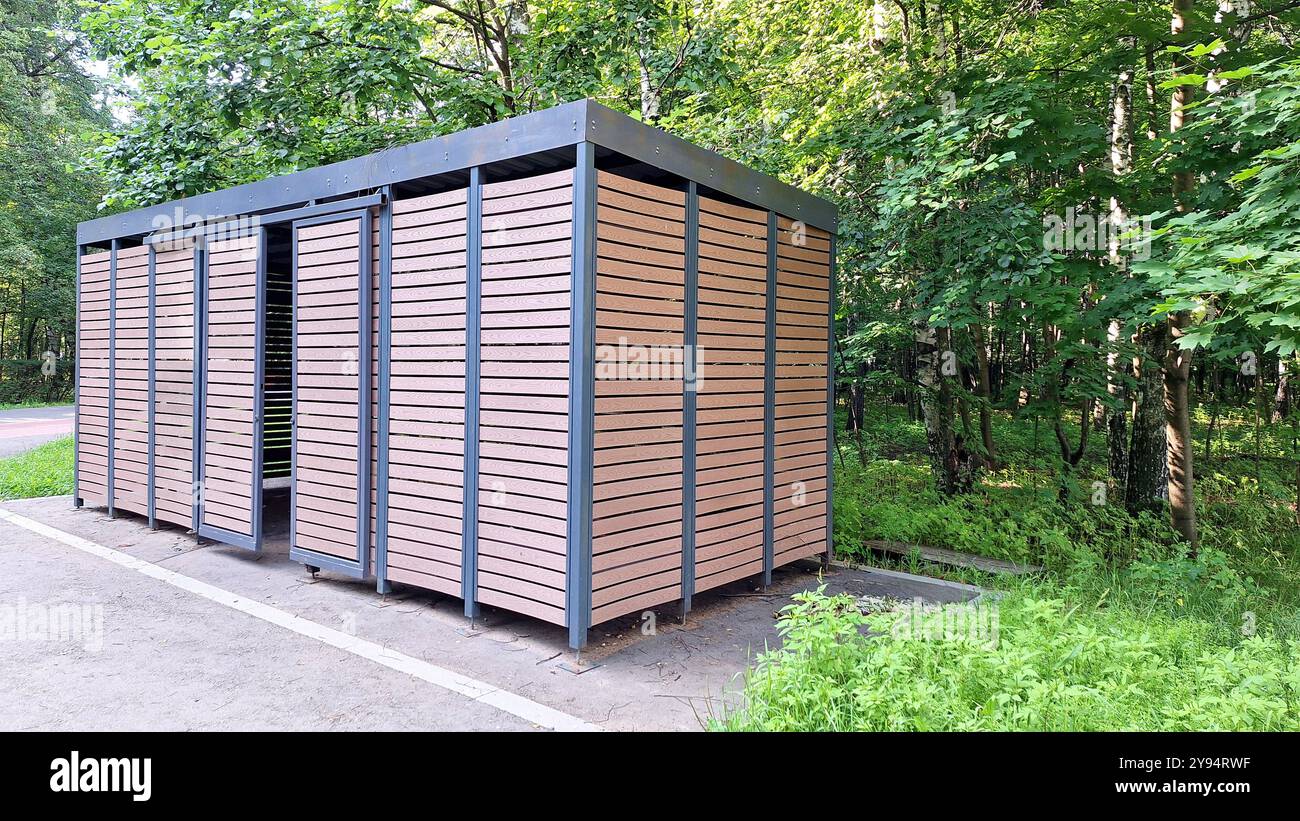 Modern wooden outdoor restroom amidst forest setting Stock Photo - Alamy