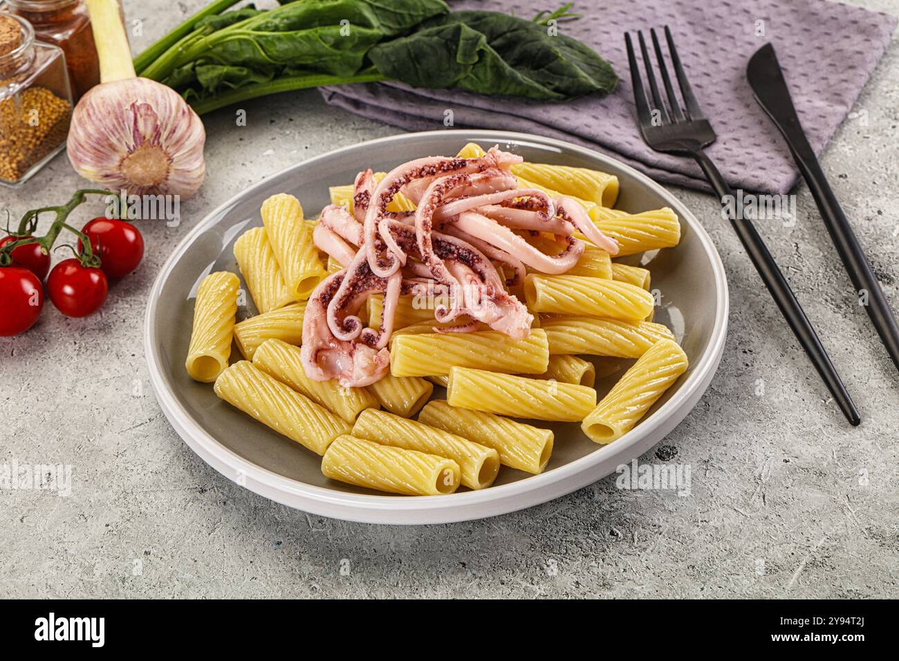 Italian cuisine - pasta tortiglioni with squid tentacles Stock Photo ...