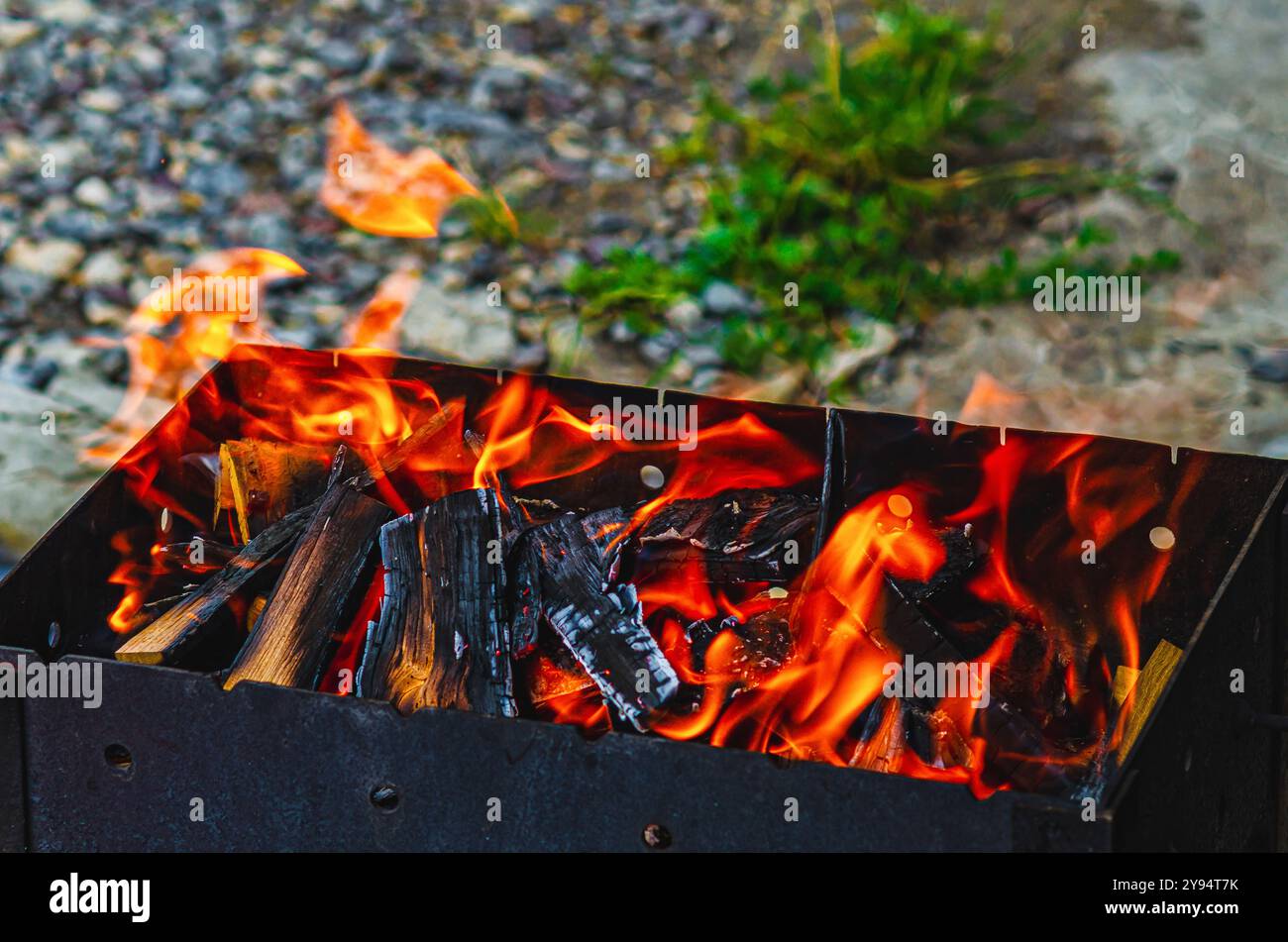 Hearth in a metal brazier. Lighting a fire for cooking barbecue Stock ...
