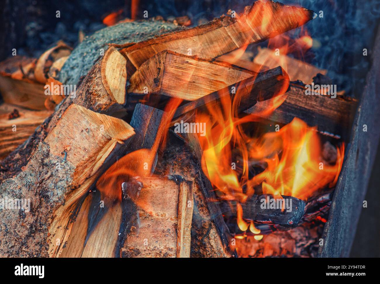 Firewood is burning in the barbecue. Lighting a fire for cooking ...