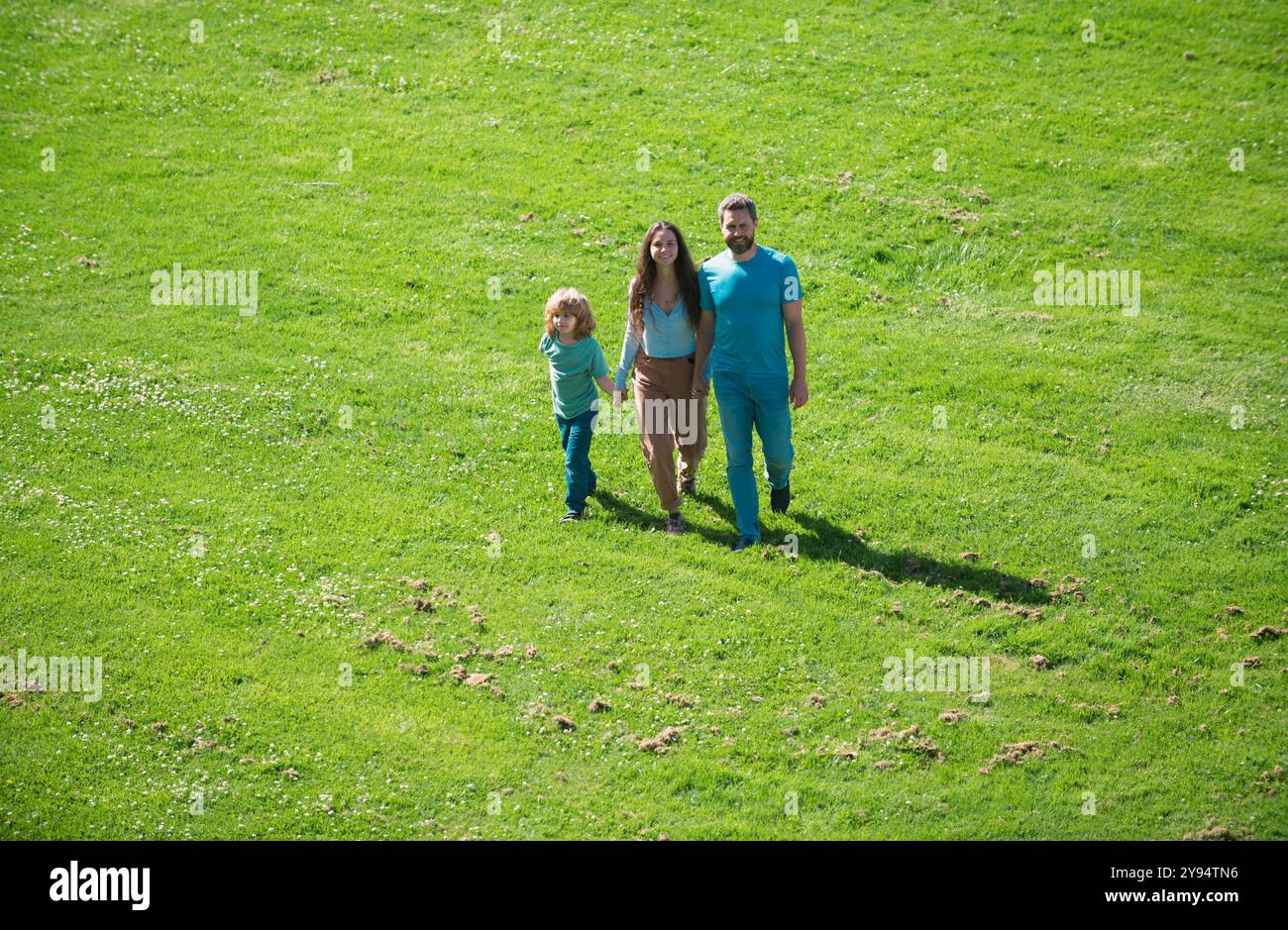 Portrait of a happy smiling family walking in park. Parents and ...
