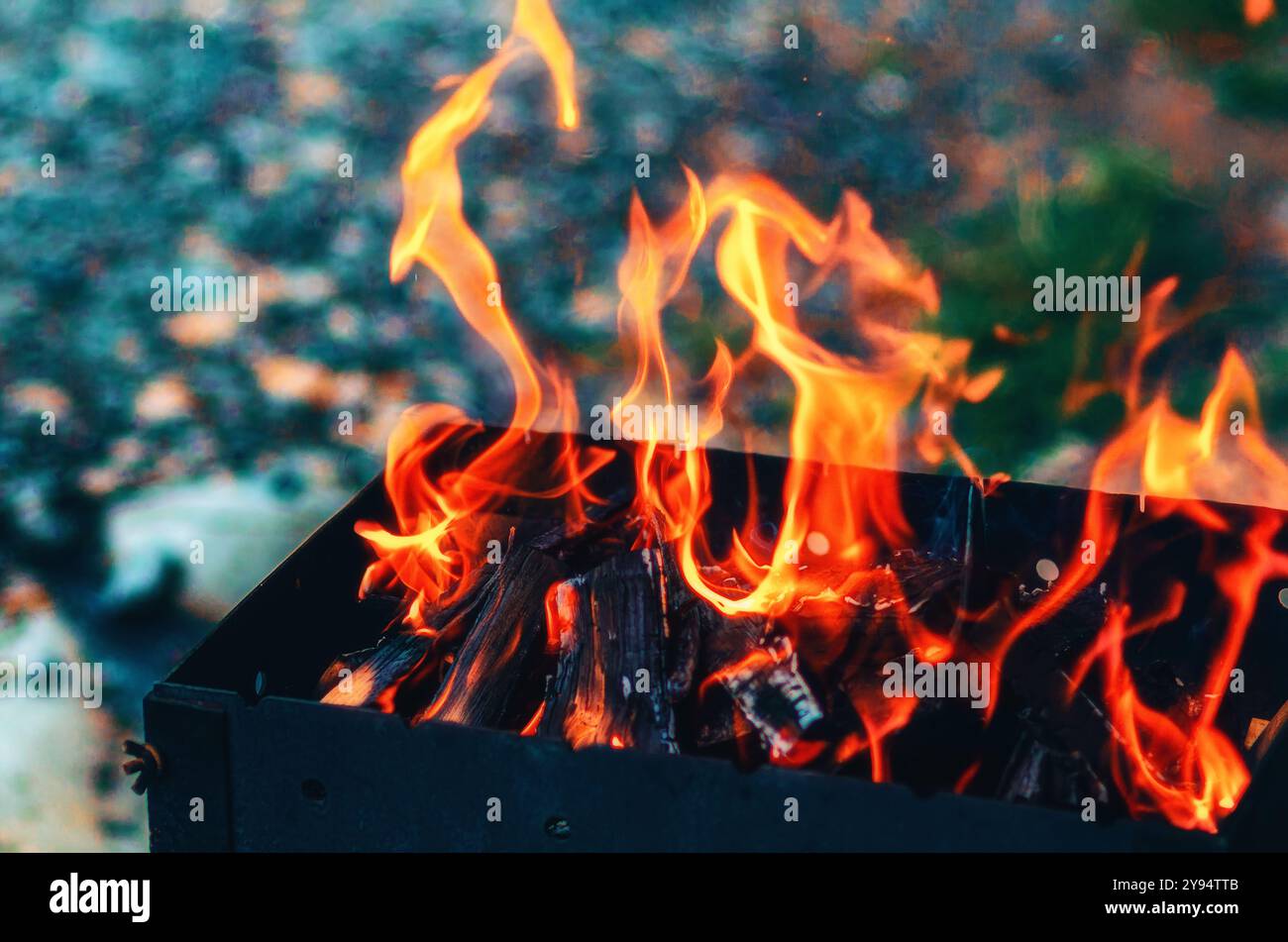 Hearth in a metal brazier. Lighting a fire for cooking barbecue Stock ...