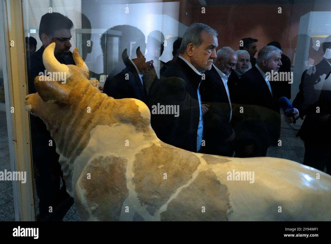 Iranian President Masoud Pezeshkian, center, visits the National Museum ...