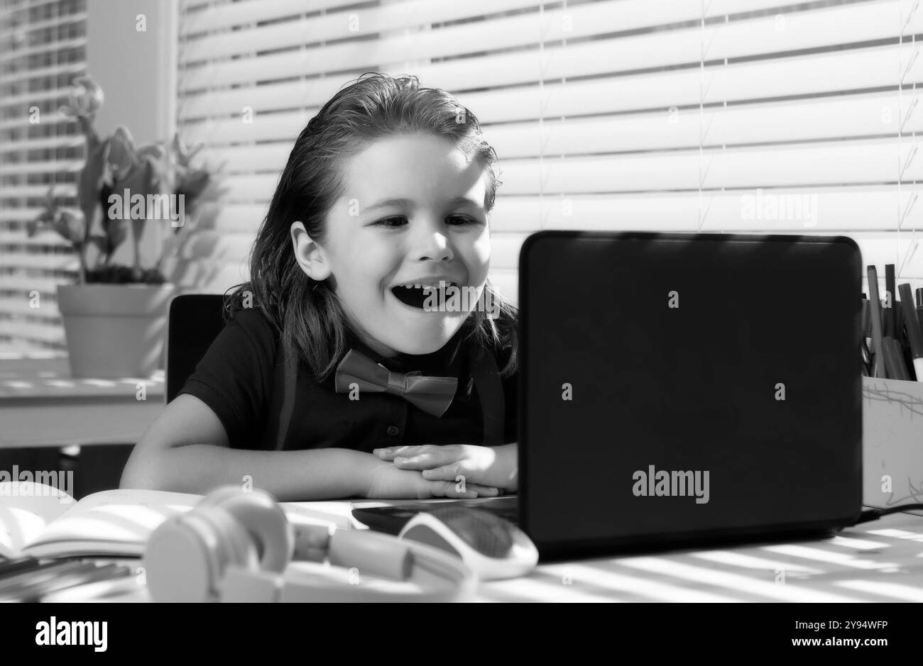 Schoolboy studying homework math during her online lesson at home ...