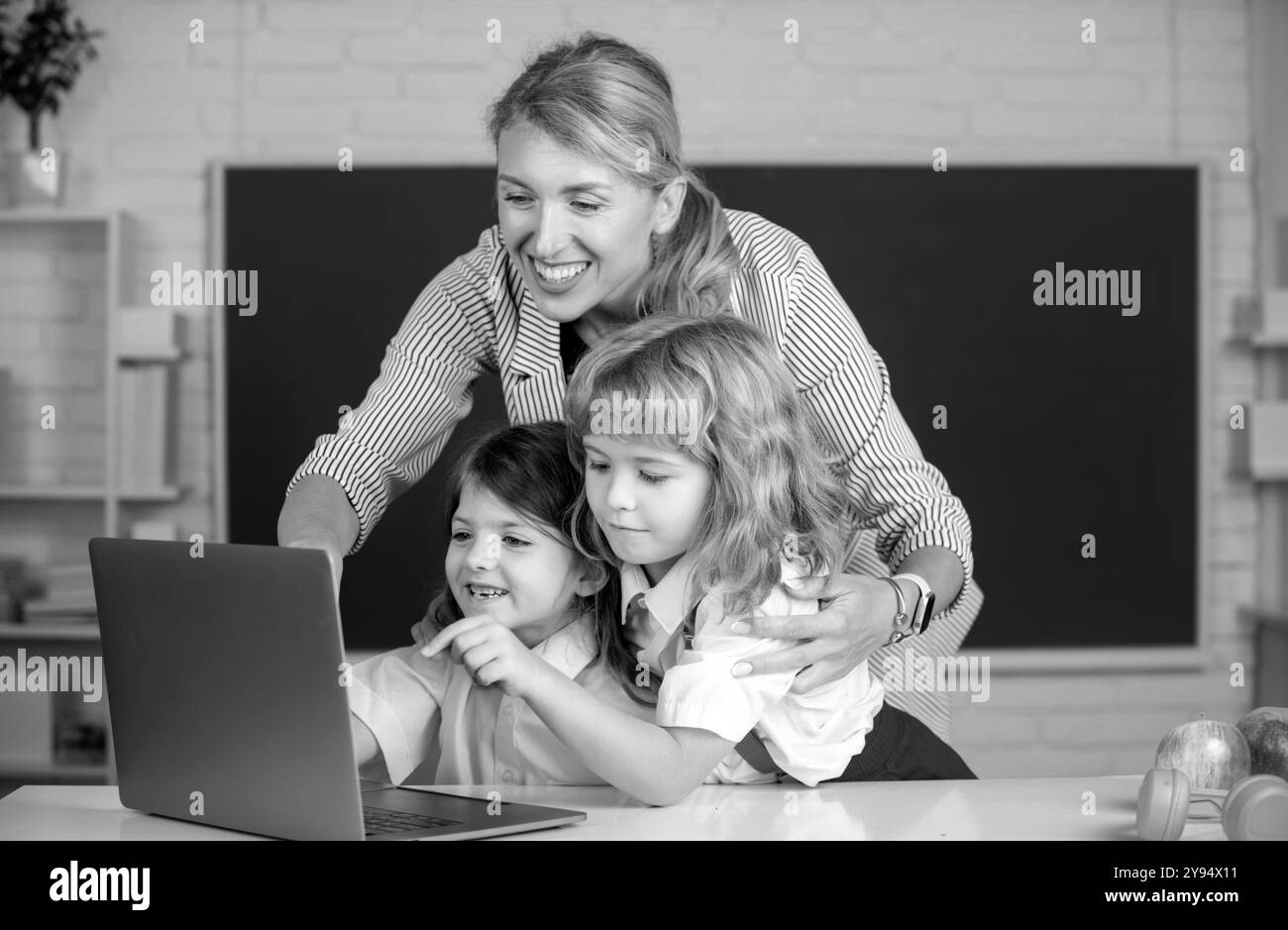 Kids learning with teacher. Children from elementary school study at ...