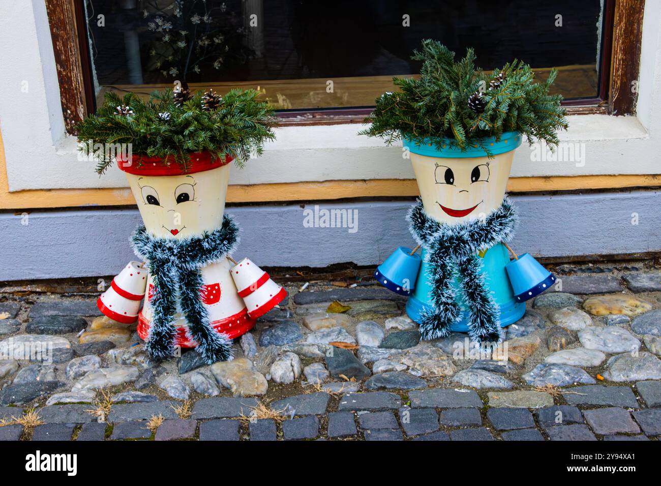 Two cute flower pots sitting on the sidewalk Stock Photo - Alamy