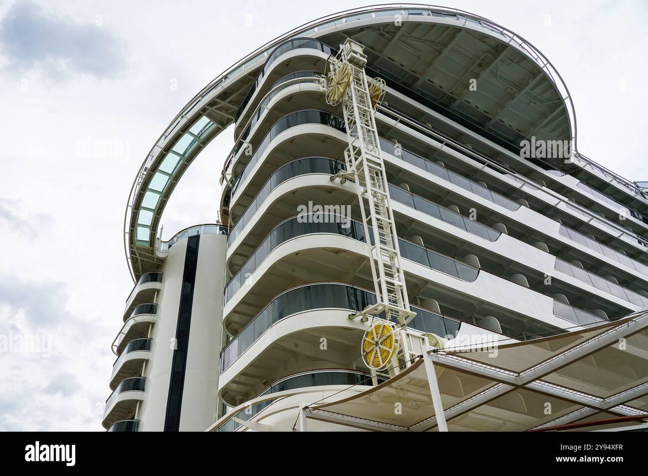 High stern of a large cruise ship with balconies on a sky background ...