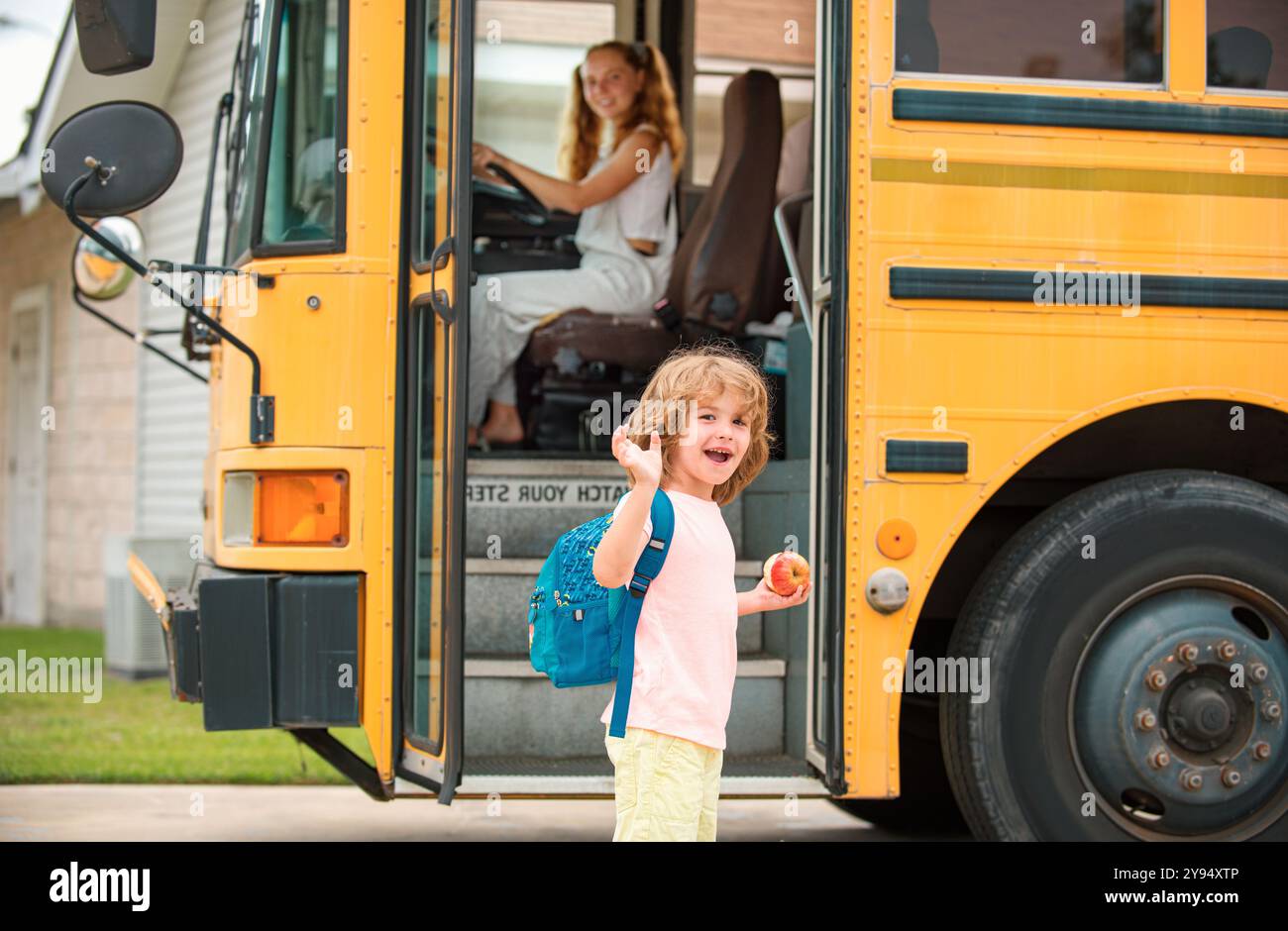 Child getting on school bus. Back to school and happy time. Little ...