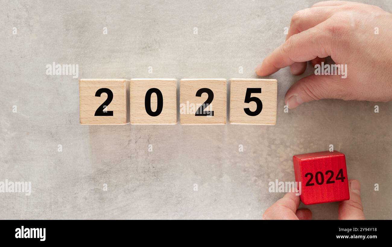 ending year 2024 and beginning 2025. wooden blocks with year 2025, gray ...