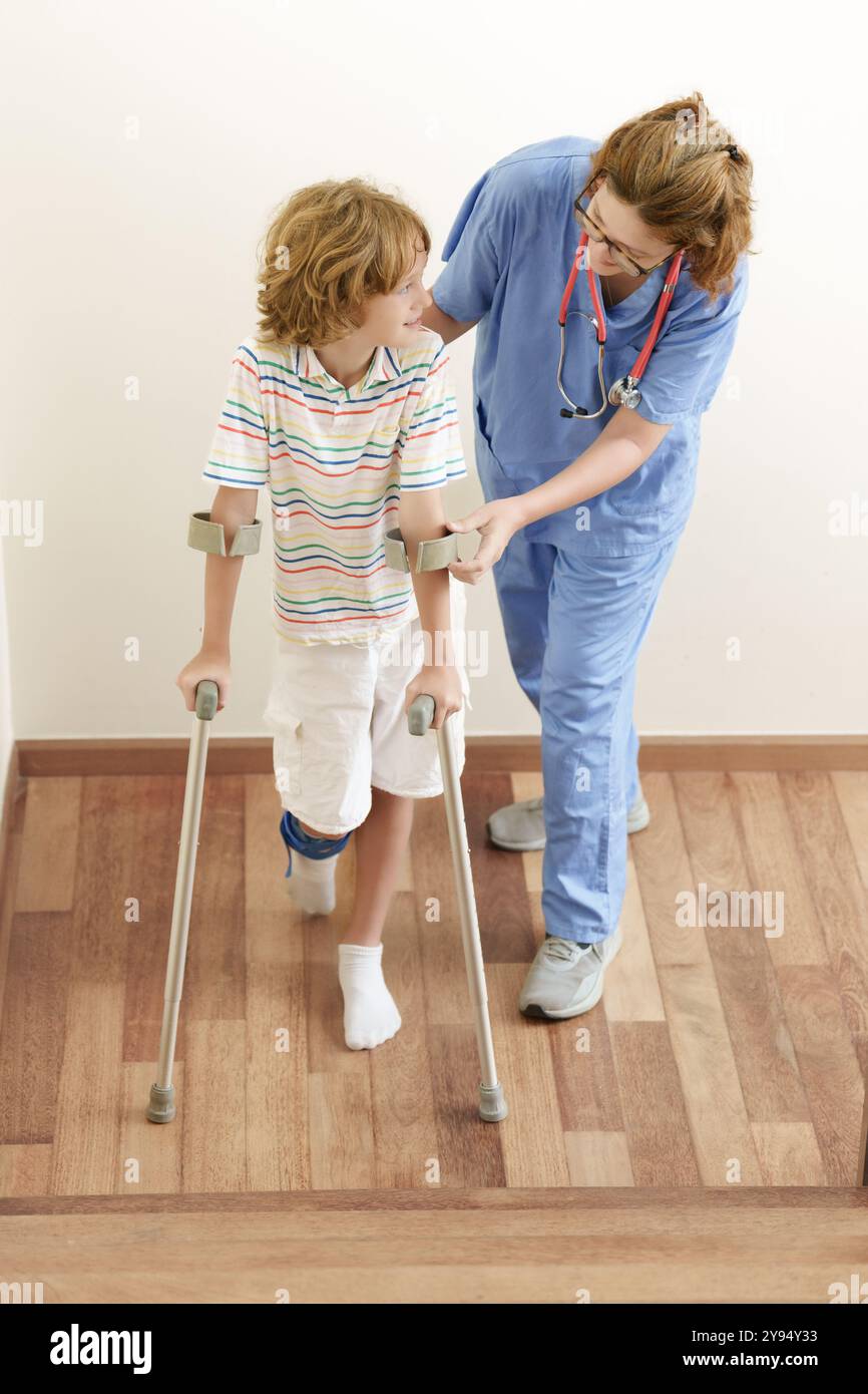 Injured child on crutches. Boy in cast on foot and leg. Little kid with ...