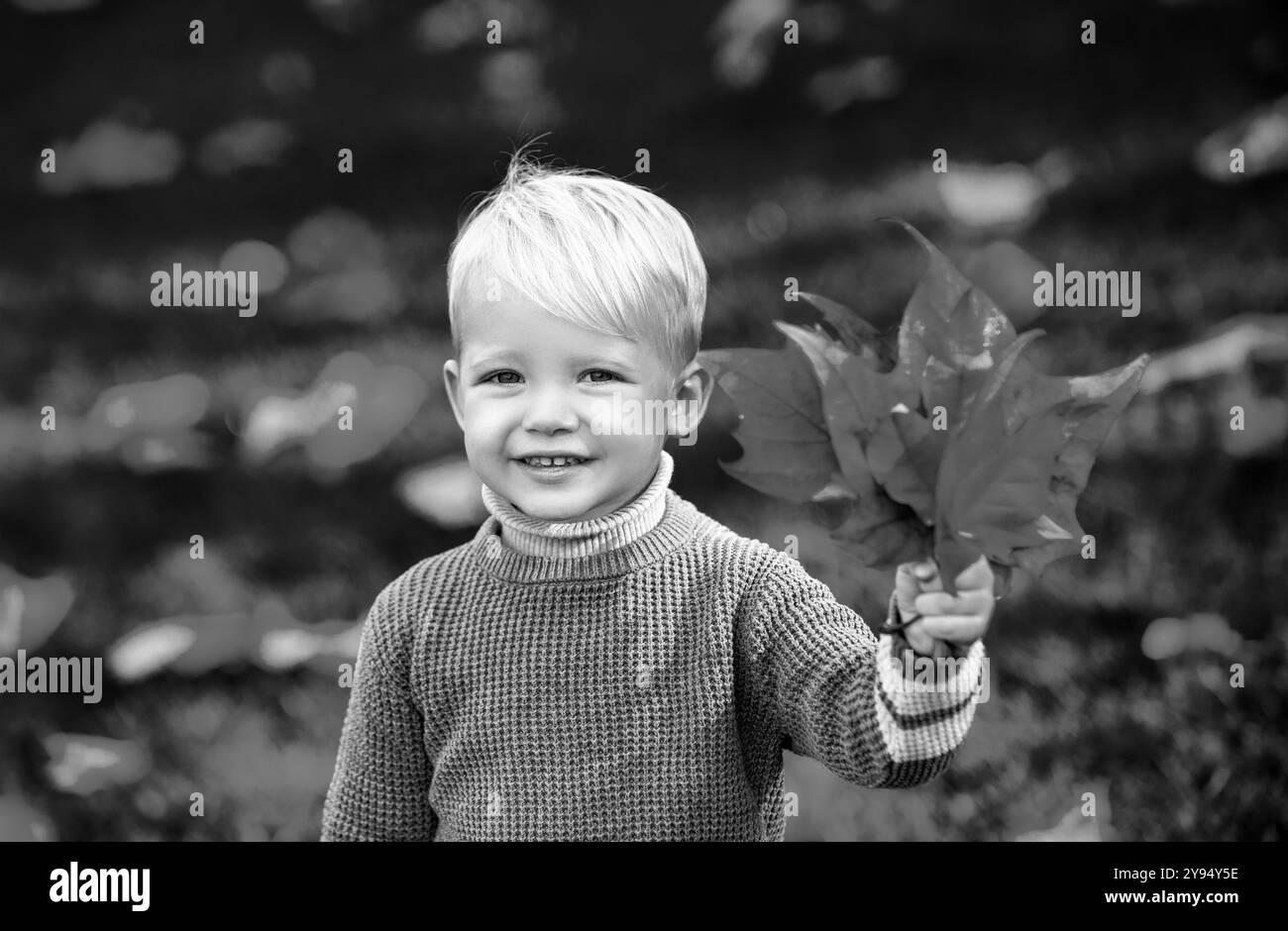 Happy child laughing and playing in autumn fall leaves on nature walk ...