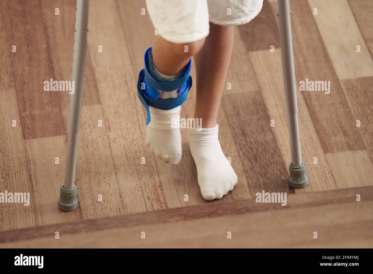 Injured child on crutches. Boy in cast on foot and leg. Little kid with ...