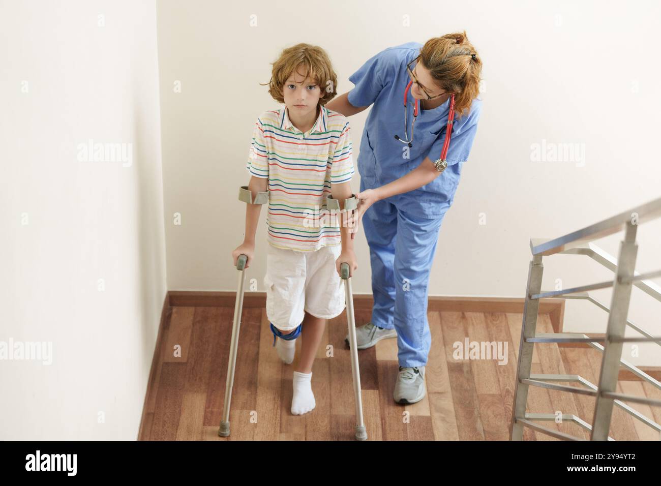 Injured child on crutches. Boy in cast on foot and leg. Little kid with ...