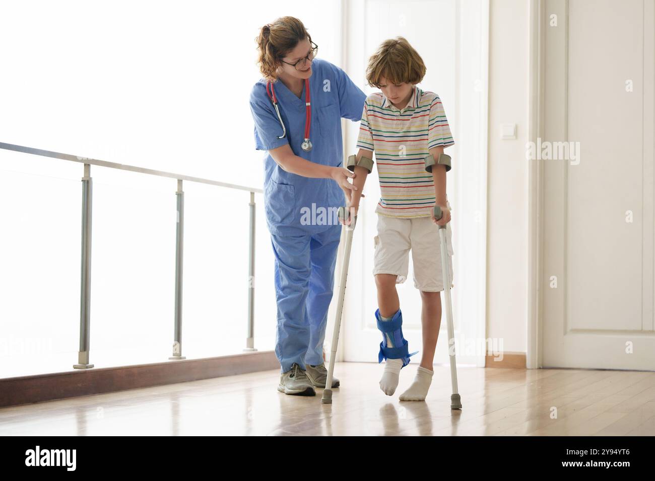 Injured child on crutches. Boy in cast on foot and leg. Little kid with ...