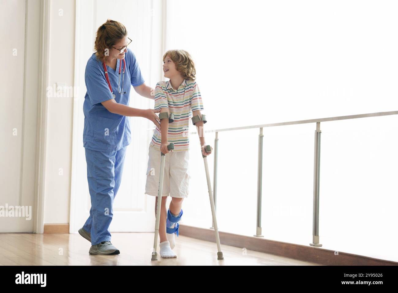 Injured child on crutches. Boy in cast on foot and leg. Little kid with ...
