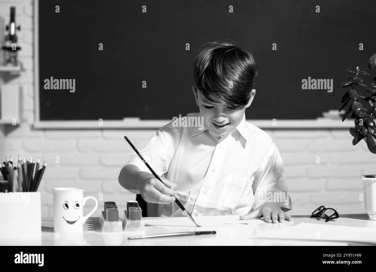 Child boy at school draws with paints. Kids artist creativity. kid ...