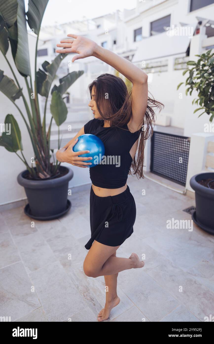 A stunning and dynamic dance pose featuring a globe set in a ...