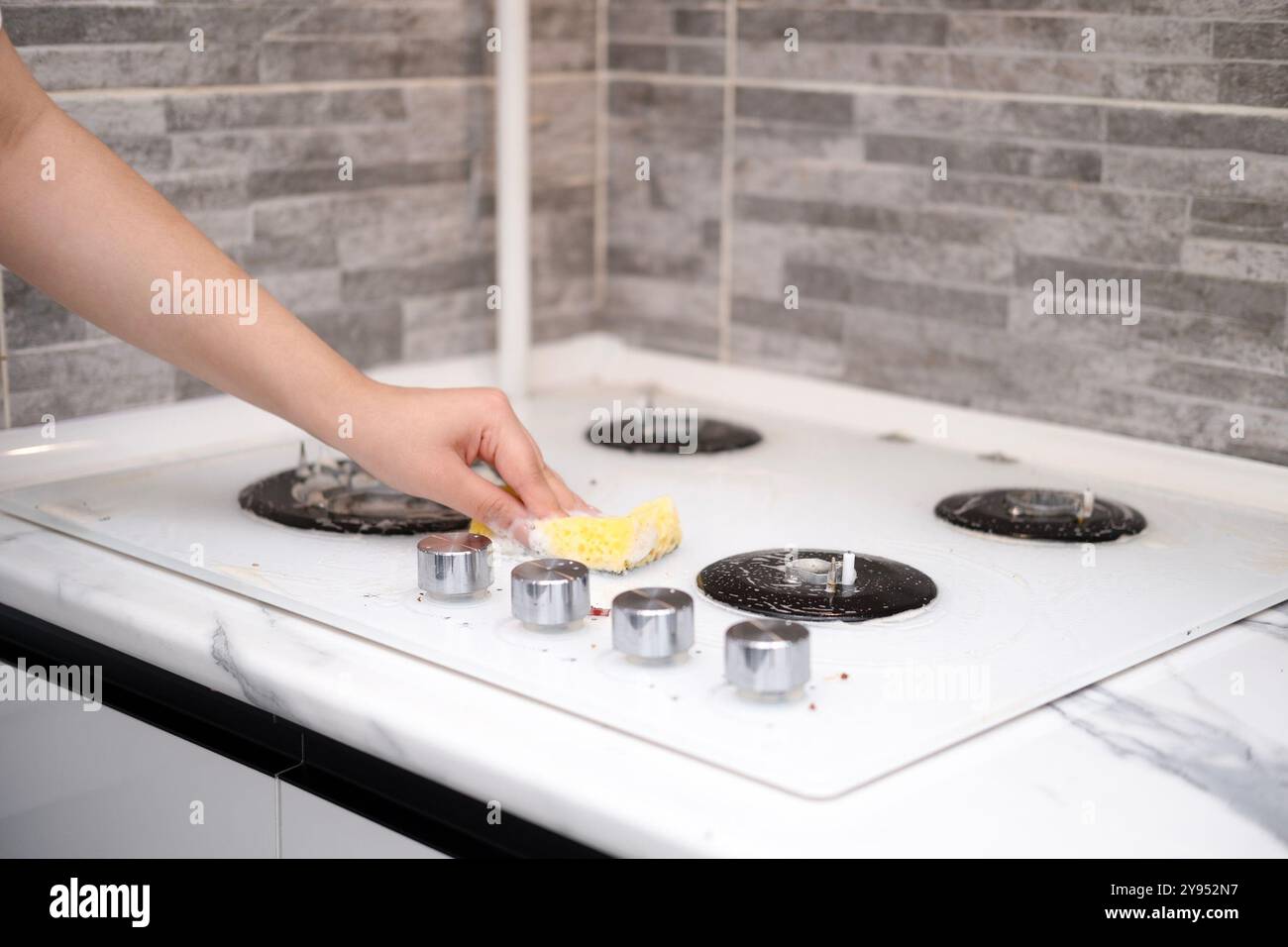 Girl washing gas stove Stock Photo - Alamy