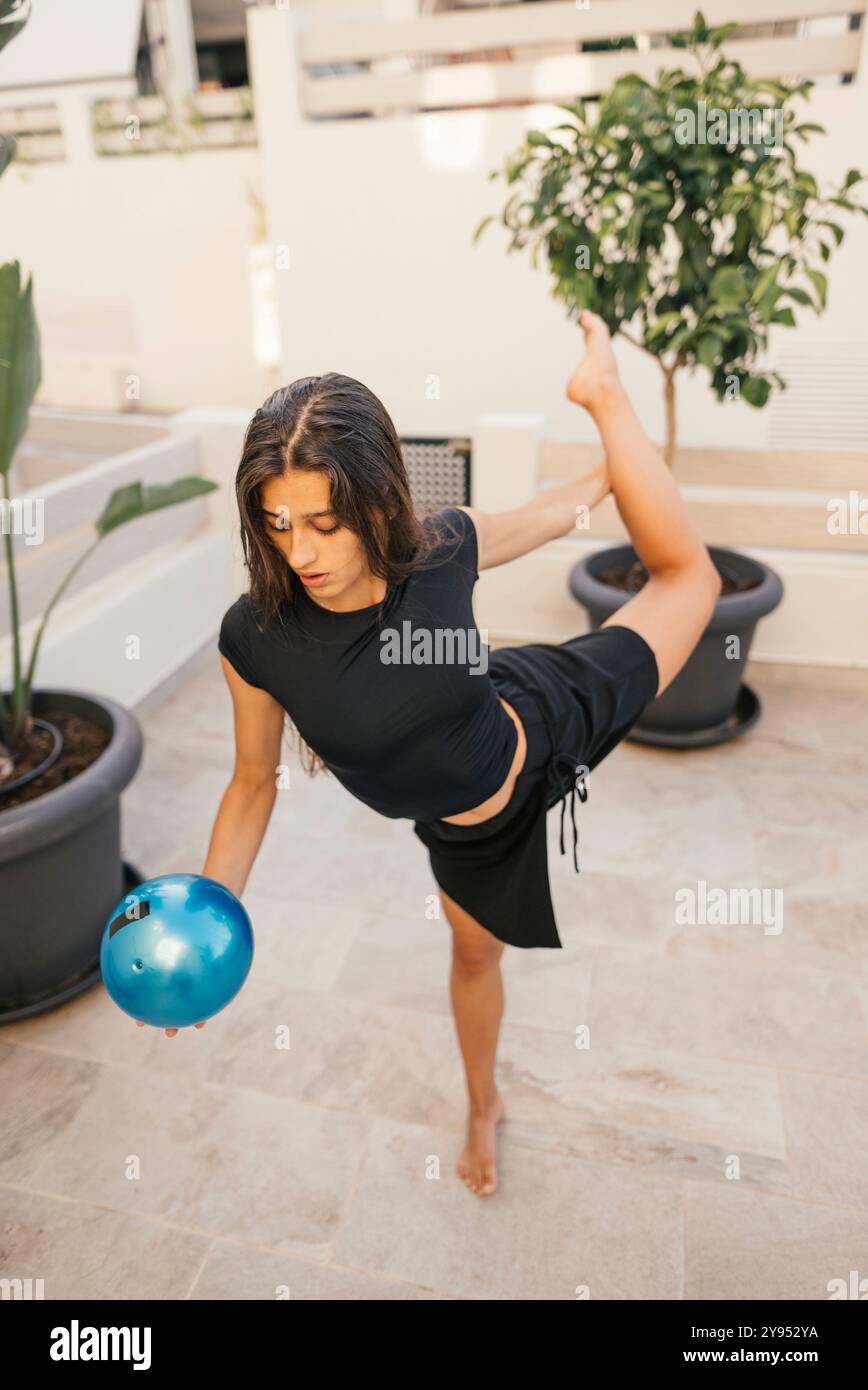Dynamic Fitness Pose Featuring a Blue Ball for Enhanced Exercise ...