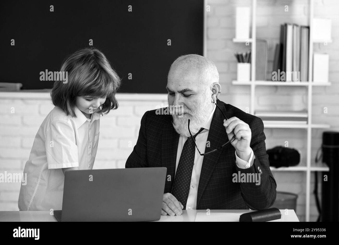 Pupil learning. Boy elementary school. Old and Young. Professor and ...