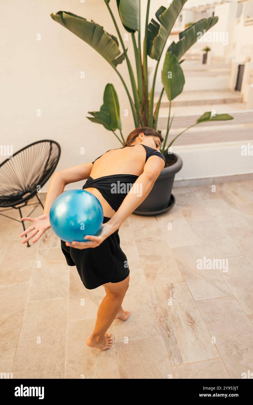 Engaging in Dynamic Yoga Pose using a Stability Ball in a Stylish and Modern Setting Stock Photo ...