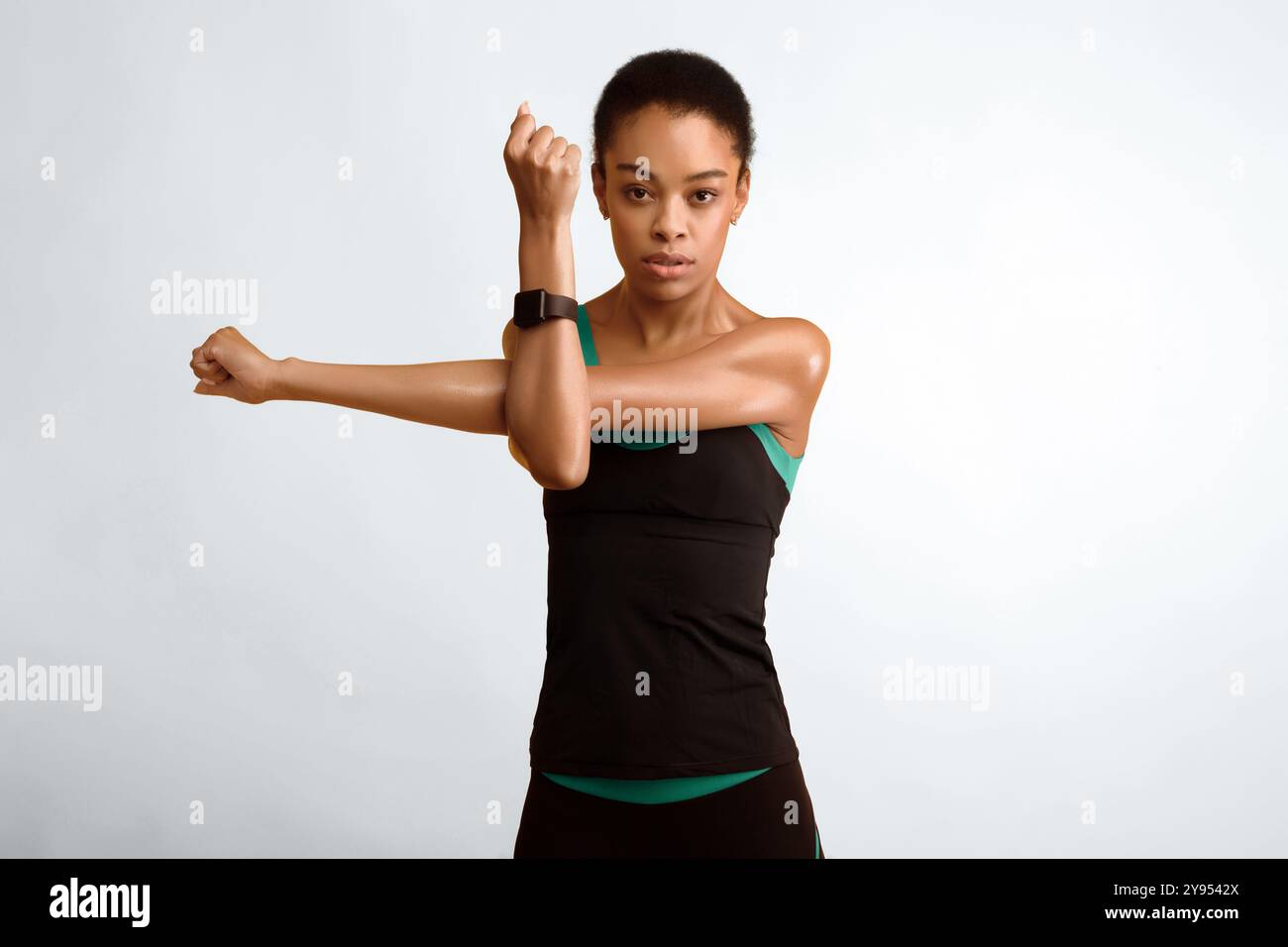 Afro Girl Doing Deltoid Arm Stretch Exercise Over Yellow Background ...