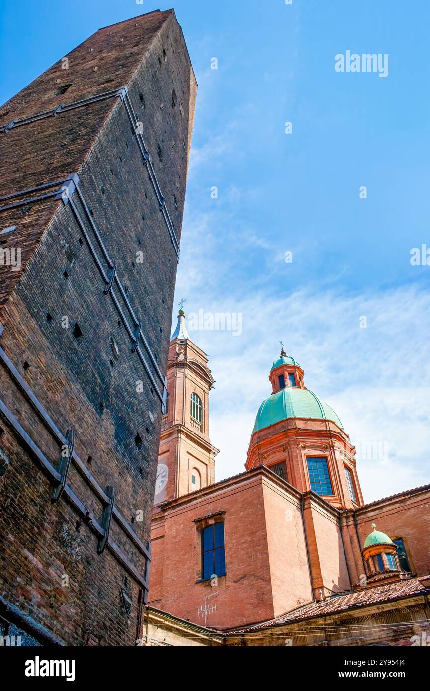 The Leaning medieval Tower of Bologna and the dome of Saints Bartolomeo ...