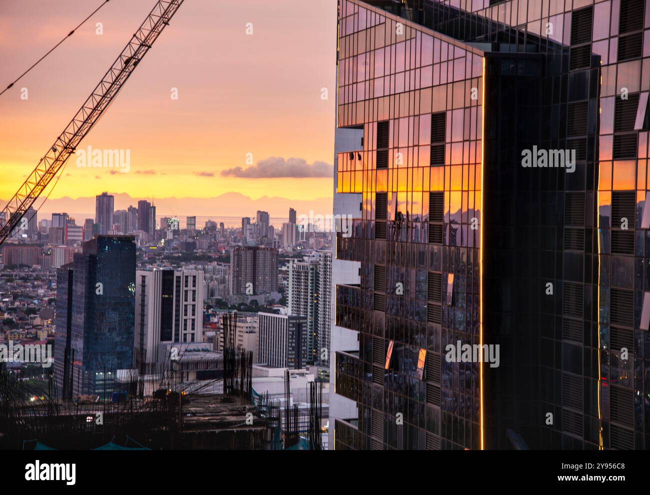Manila,Luzon,The Philippines-May 19 2023: The setting sun casts warm ...