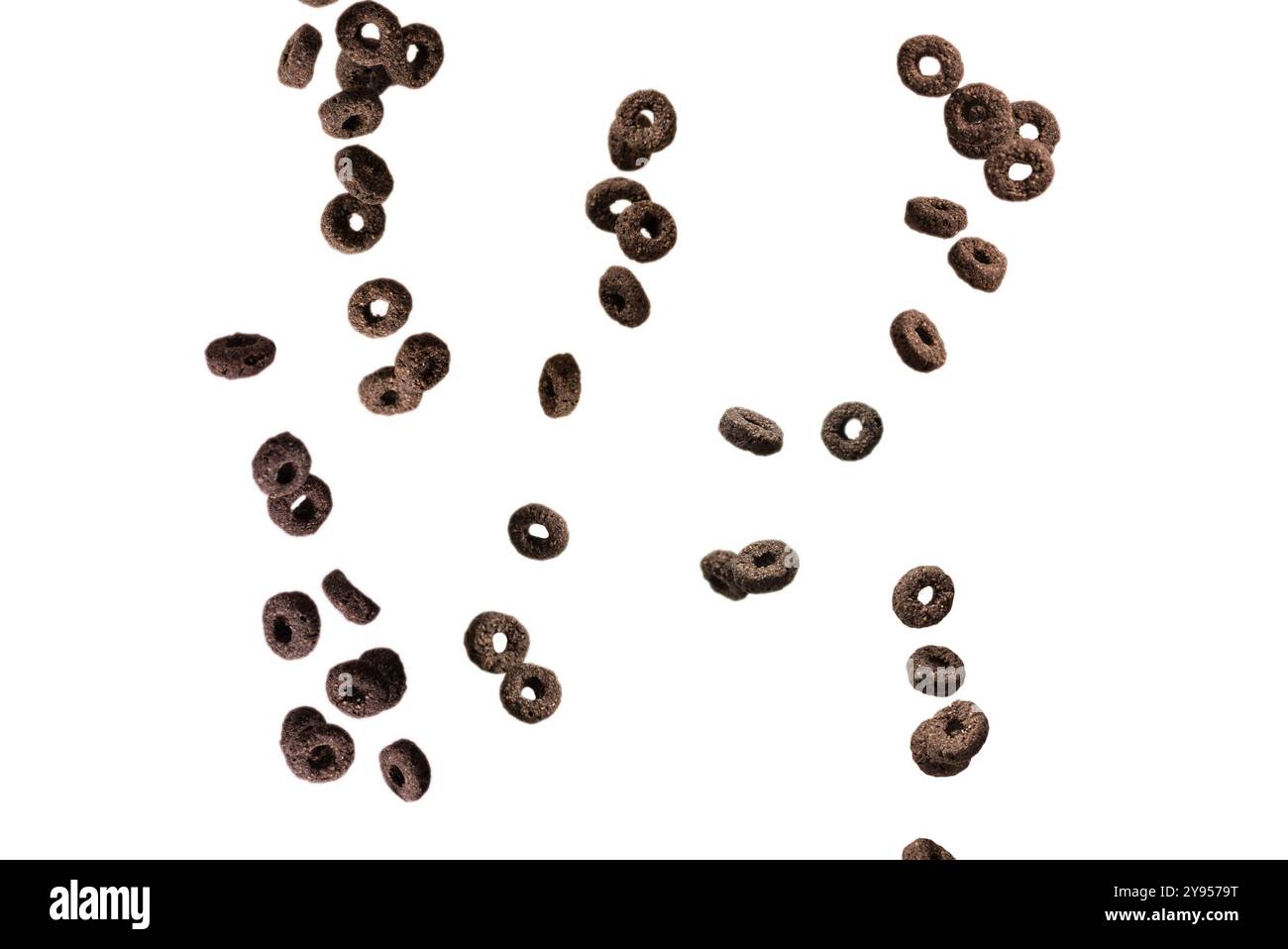 Chocolate rings cereal spill out into a bowl. Breakfast. Isolated on a ...