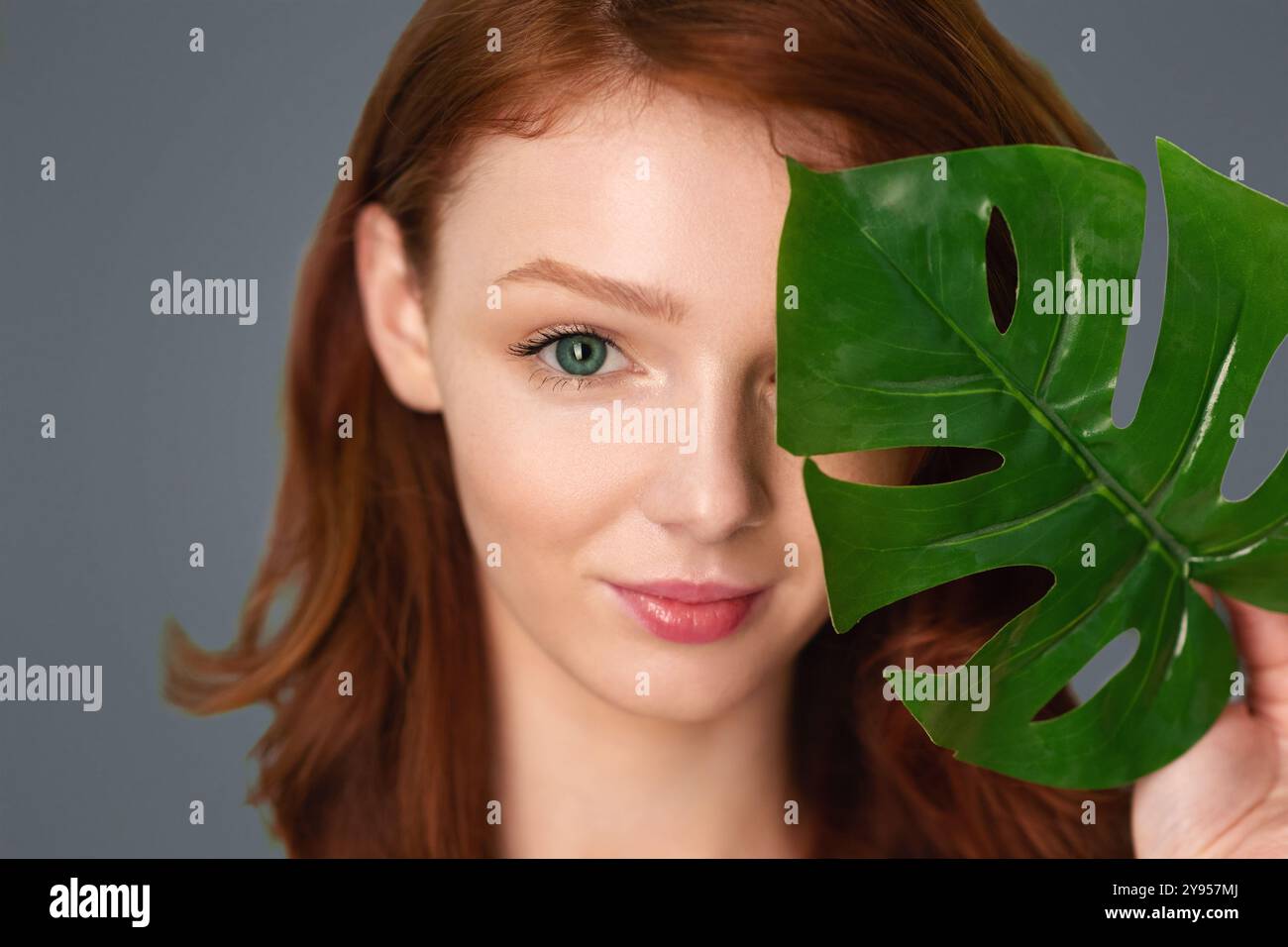 Red-Haired Young Woman Posing With Tropical Leaf Over White Background ...