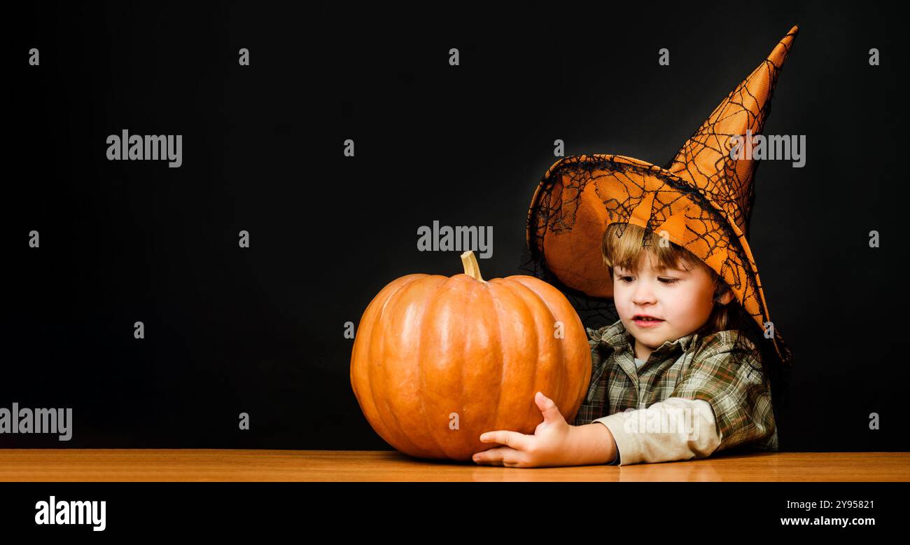 Happy Halloween holidays. Halloween child in witch hat with Halloween ...