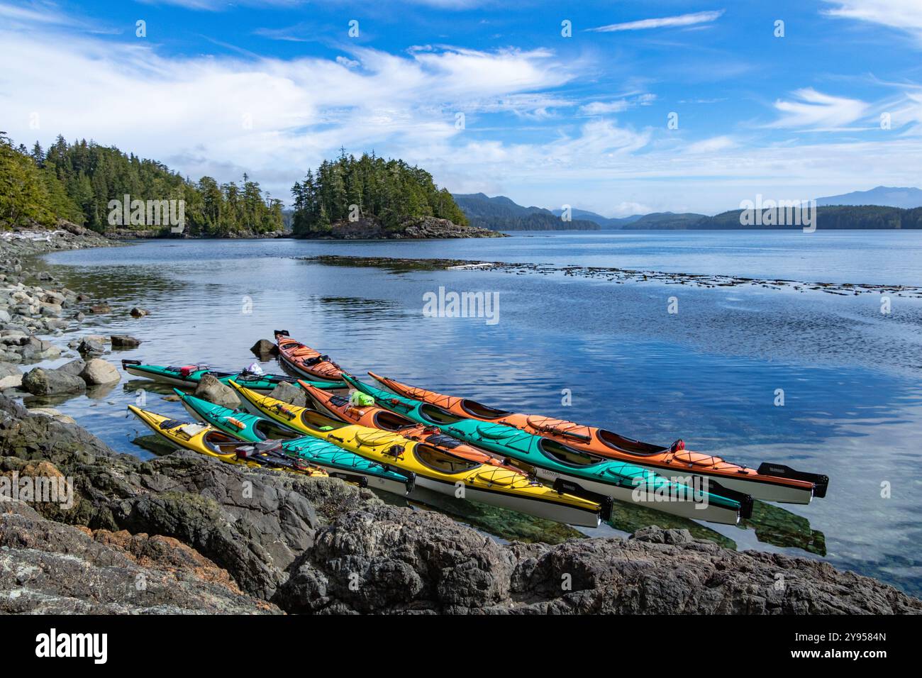 Colourful kayaks at seashore in front of sunny seascape Hanson Island ...