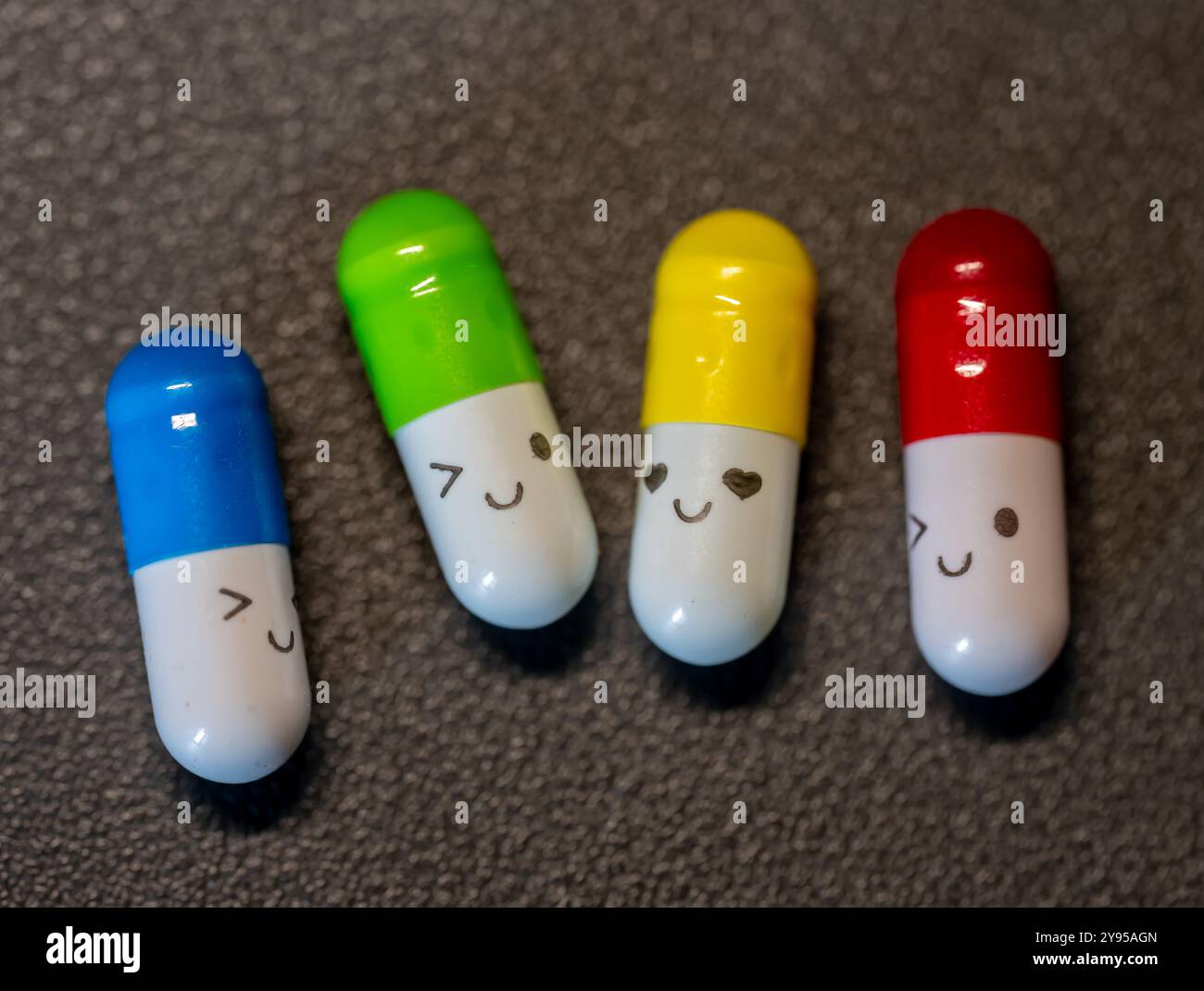 Tiny pills smiling with faces Stock Photo - Alamy