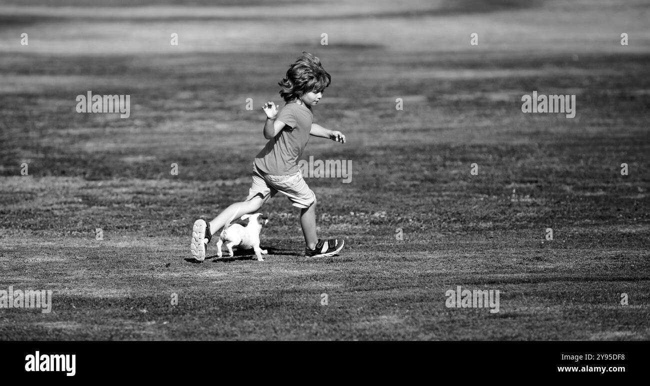 Running dog. Happy child run with a dog outdoor Stock Photo - Alamy
