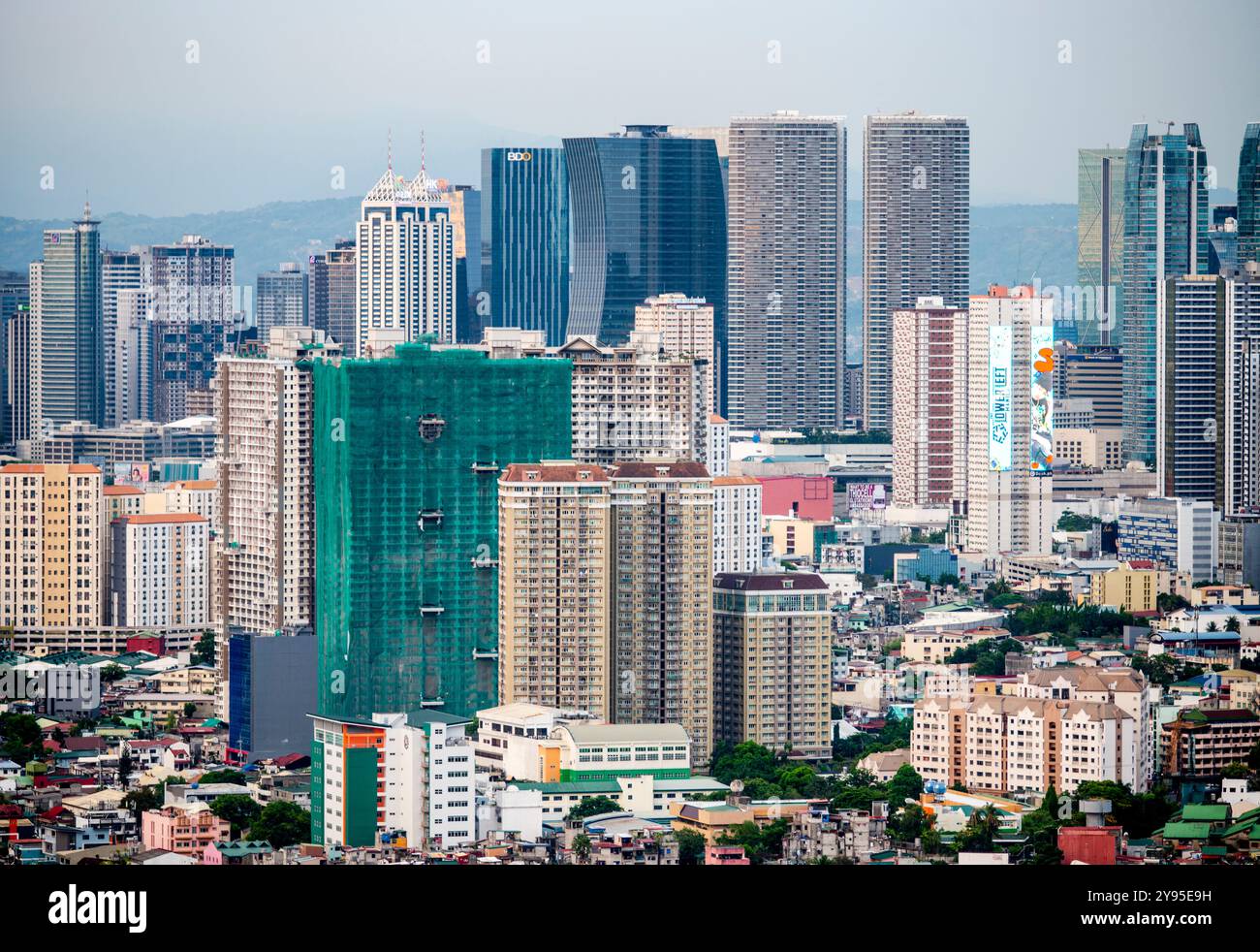 Manila,Luzon,The Philippines-May 19 2023: The setting sun casts warm ...