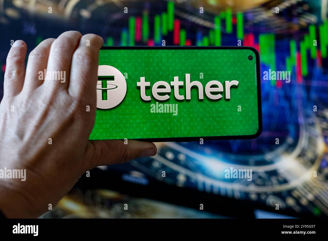 In this photo illustration, the Tether (USDT) logo seen displayed on a smartphone with stock ...
