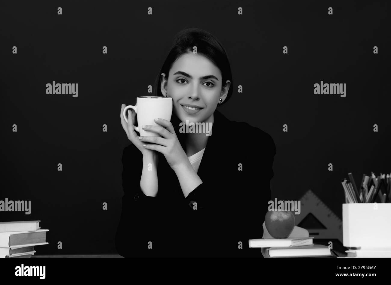 Student with cup drinking tea in classroom. Coffee break in university ...