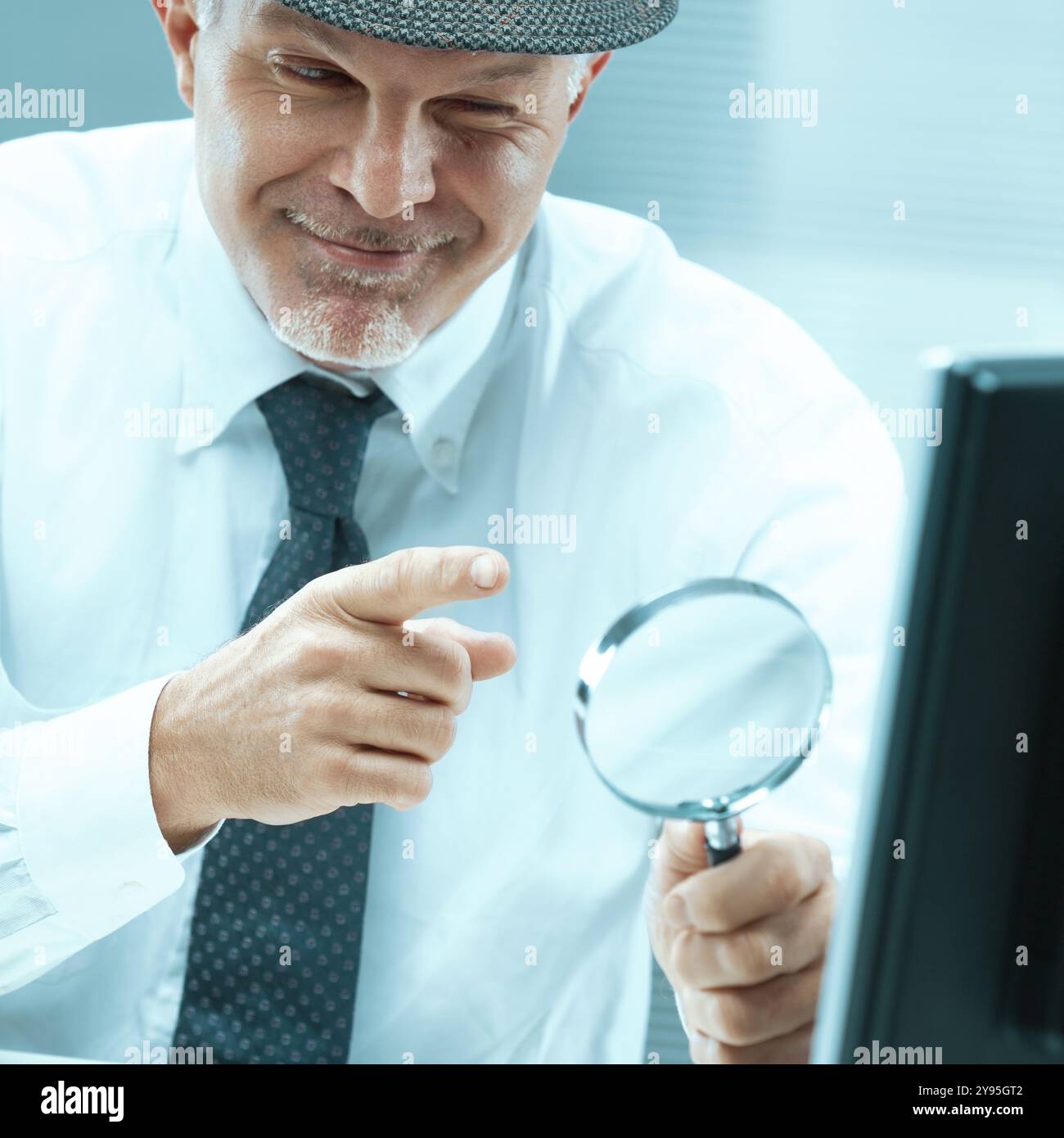 Man wearing a flat cap conducts a meticulous investigation with a magnifying glass, symbolizing ...
