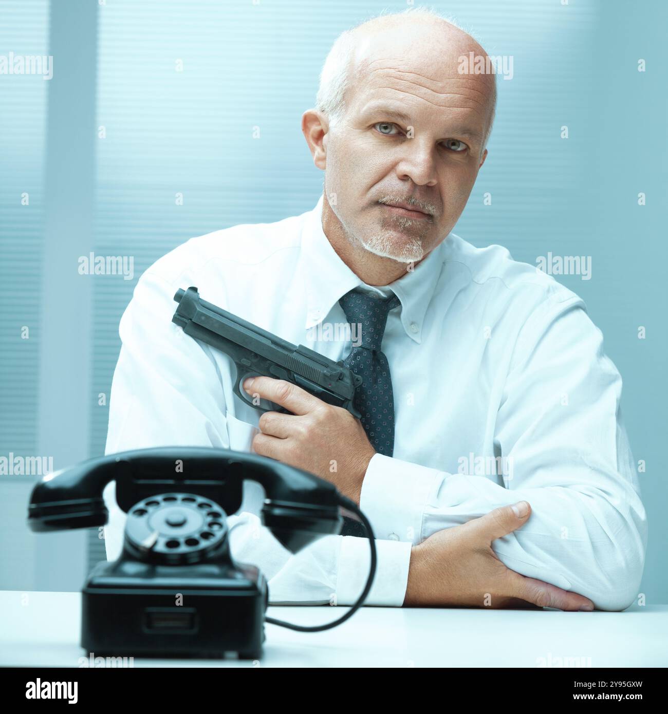 Man in professional attire exudes defiance as he brandishes a handgun ...