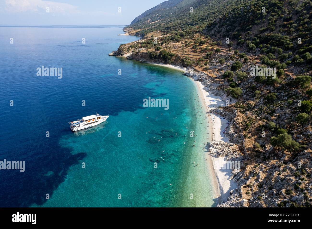 Drone Aerial view of tourists enjoying summer on a Greek isolated ...