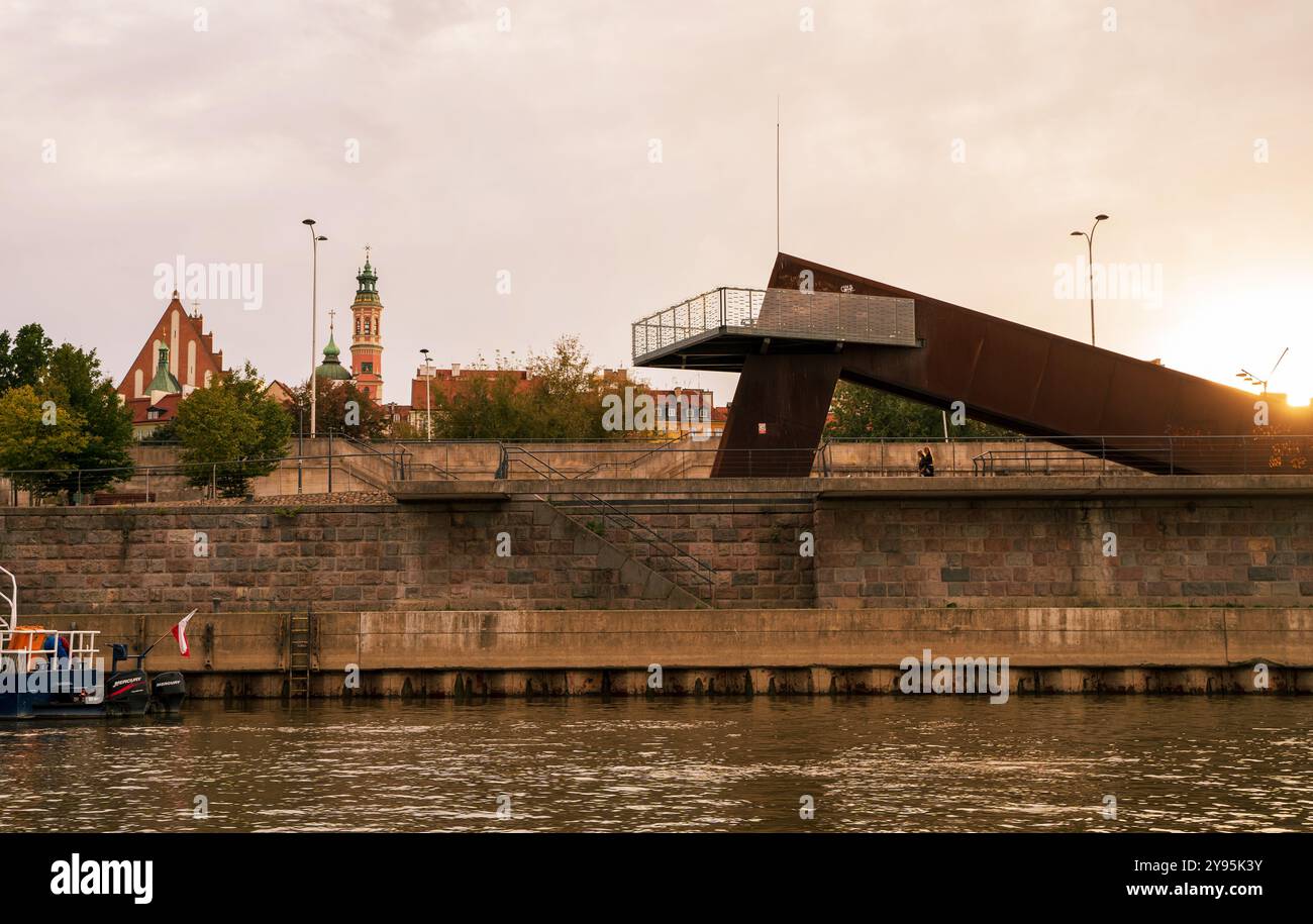A modern observation deck with a rust-colored metal structure juts out ...