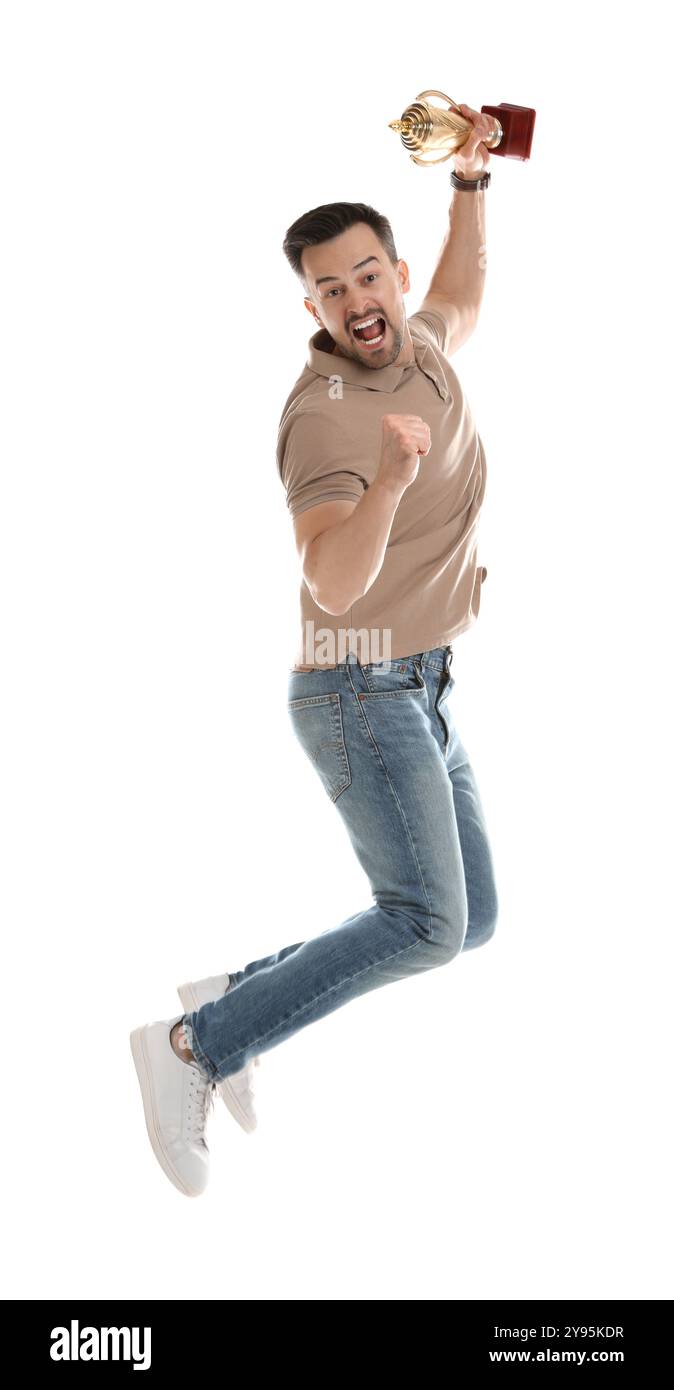 Happy winner with golden trophy cup jumping on white background Stock ...
